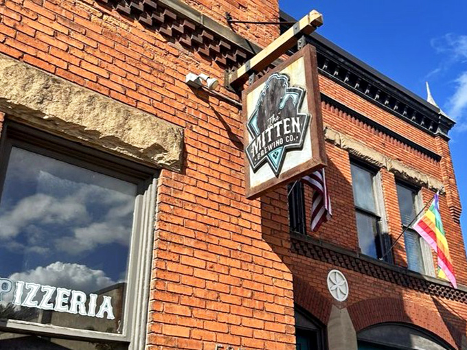 The Mitten's sign hangs like a promise of good things to come &ndash; a beacon for those seeking exceptional vegan pizza in unexpected places.