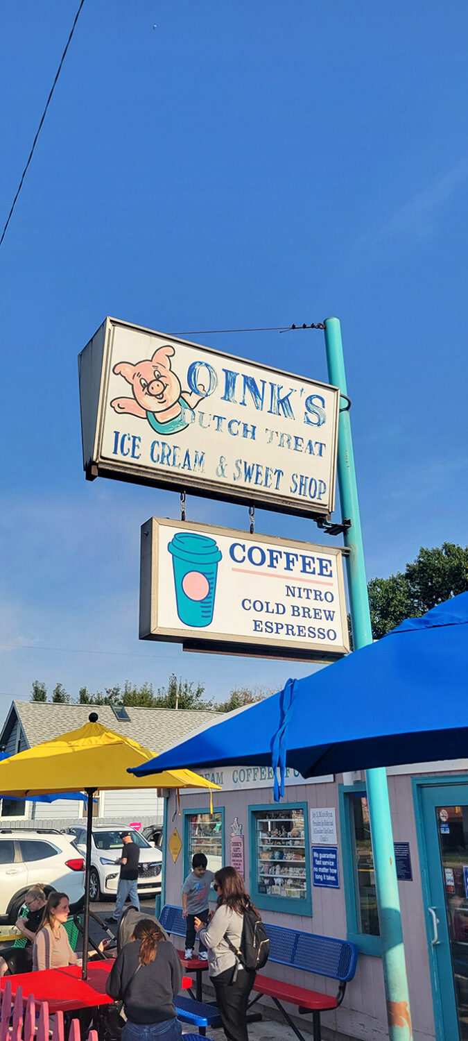 The iconic Oink's sign stands against the Michigan sky like a beacon of sweetness, guiding dessert pilgrims to their frozen promised land.