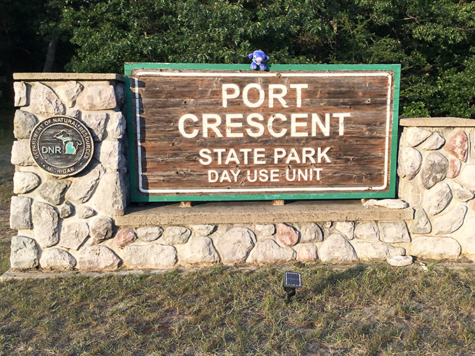 Welcome to paradise: Port Crescent's entrance sign promises adventure while the surrounding landscape delivers beyond expectations.