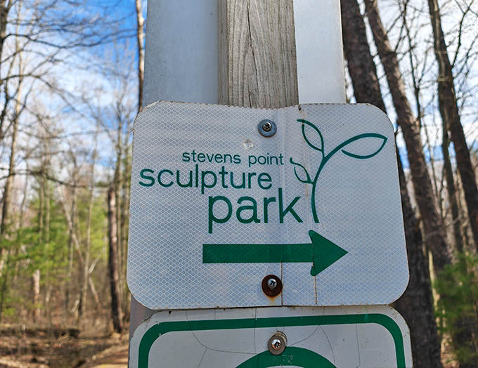 Follow the arrow to unexpected joy – this unassuming sign points the way to Wisconsin's most magical outdoor gallery.