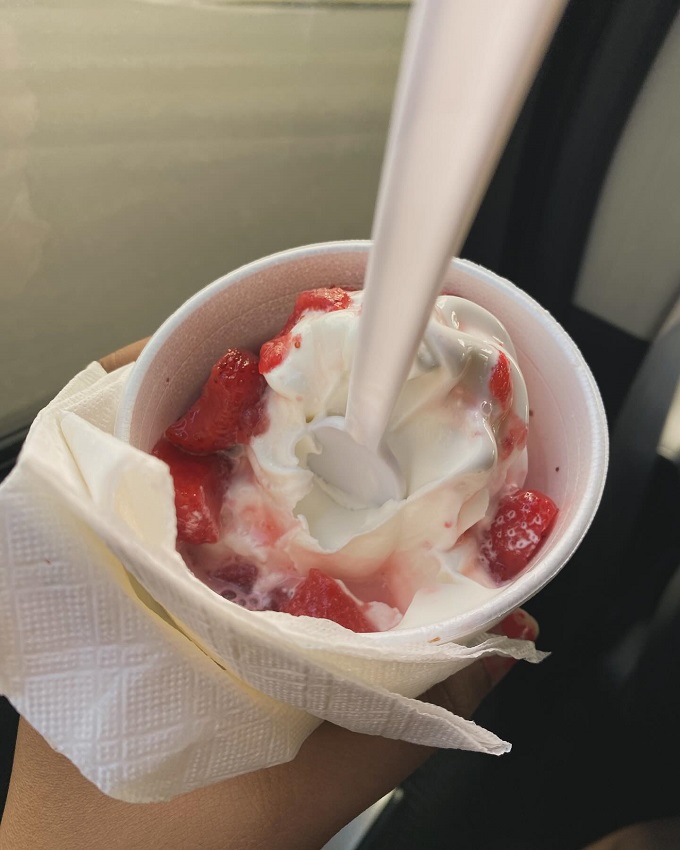 A strawberry sundae that's summer in a cup, where real fruit mingles with soft serve in a sweet symphony.