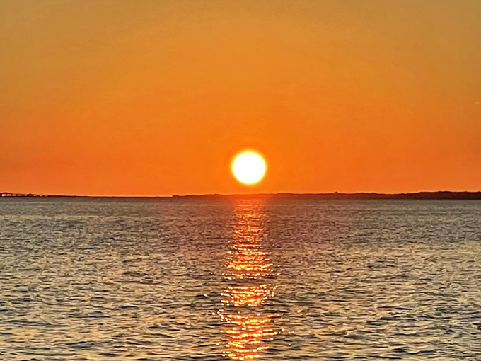 The grand finale &ndash; a Mackinac sunset paints the sky in impossible oranges, turning Lake Huron into a mirror of liquid gold.