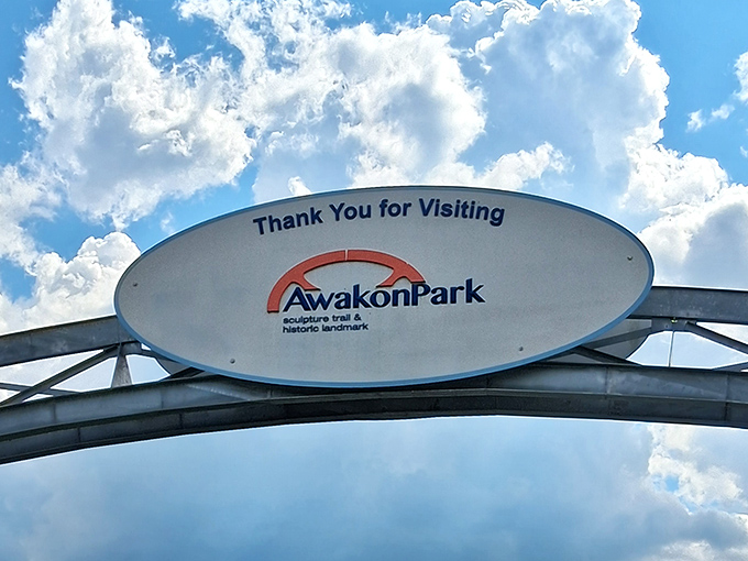 "Thank You for Visiting" says the sign, though the real thanks goes to whoever decided giant metal heads were exactly what this corner of Michigan needed.