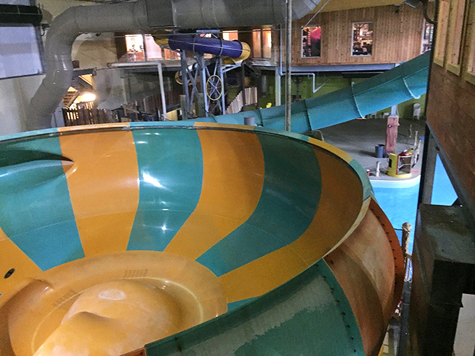 This swirling vortex of yellow and green promises a heart-racing ride before depositing thrill-seekers into the waiting pool below.