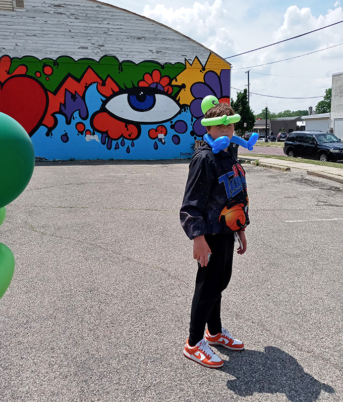 Young visitors encounter vibrant street art, where colorful murals transform ordinary walls into extraordinary backdrops for everyday adventures.