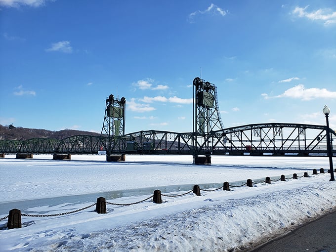 Winter transforms the lift bridge into a snow-dusted postcard scene, the frozen river below waiting patiently for spring's return.