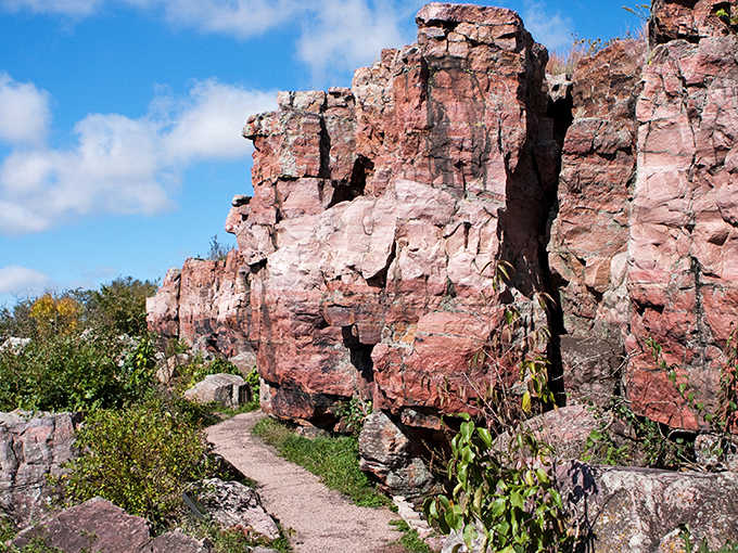 Ancient pink quartzite walls stand like nature's skyscrapers along the Circle Trail, their billion-year history etched into every crevice and shadow.