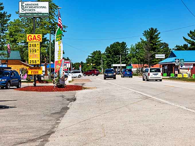Paradise, Michigan's main street welcomes travelers with small-town charm and essential services. Gas up here before exploring the natural wonders nearby!
