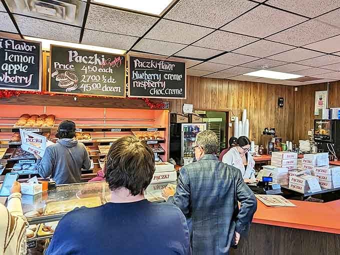 Customers line up eagerly at the counter, where decades of donut-making expertise transforms simple ingredients into morning magic.