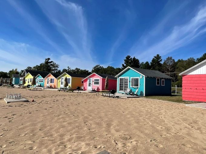 The vibrant cottages create a postcard-perfect scene against Michigan's blue skies &ndash; Caribbean vibes without the passport!