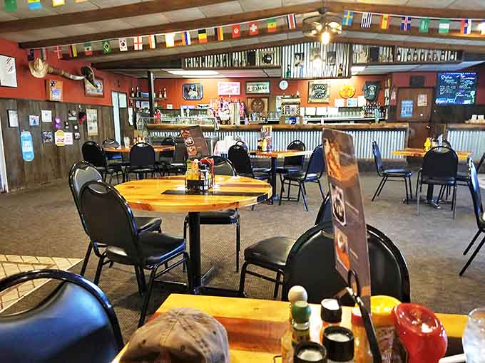 Step inside to discover a world traveler's dream &ndash; international flags dance overhead while wooden tables invite you to settle in for a global feast.