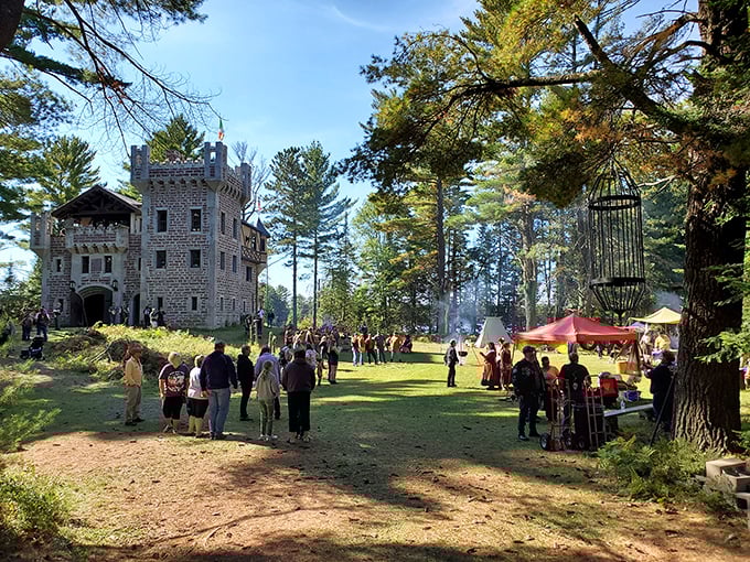 Medieval magic comes alive during the annual festival, where visitors gather on the castle grounds surrounded by towering pines and colorful tents.