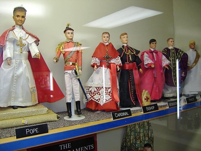 Tiny clerical figures stand at attention, from humble Pope to ornate Cardinal, each doll meticulously dressed in miniature versions of ceremonial garb.