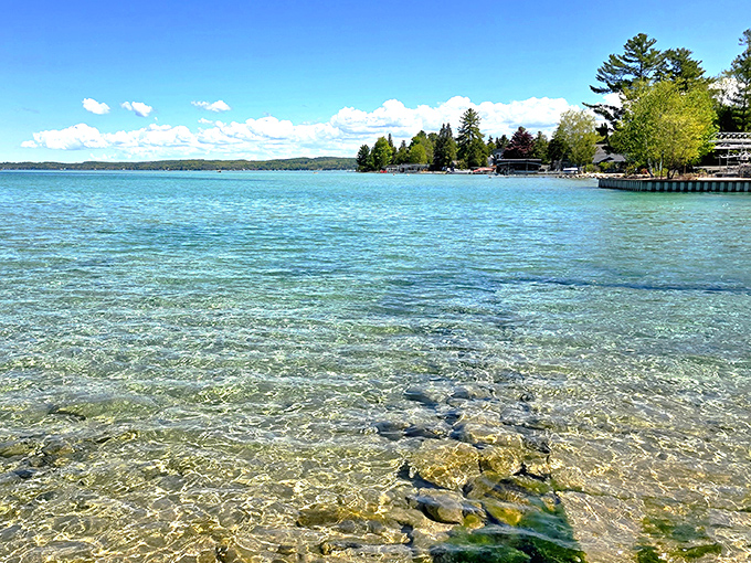 Crystal clear shallows reveal every pebble beneath the surface &ndash; like swimming in liquid glass with a turquoise tint that rivals any tropical destination.