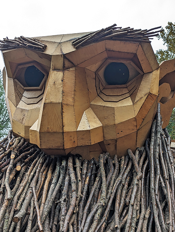 The intricate facial details reveal the extraordinary craftsmanship behind this woodland giant, each geometric wooden piece creating expressive features.
