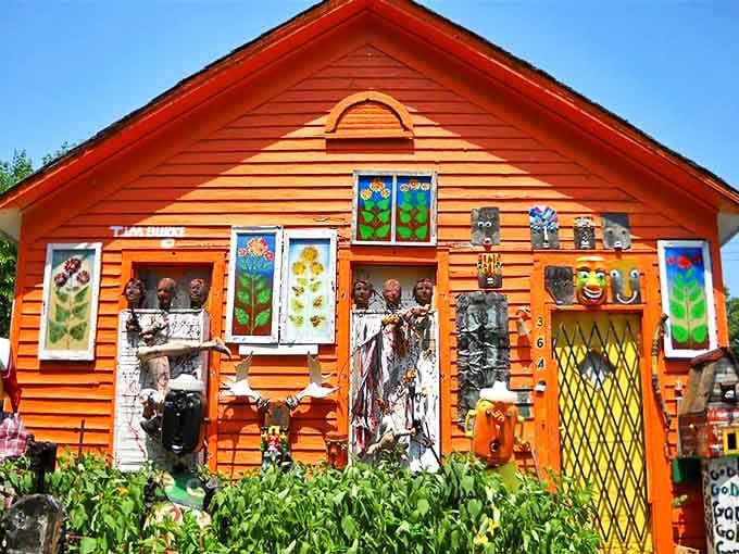 Sunlight dances across the gallery's front, where stained glass flowers and curious faces transform an ordinary building into a living canvas.