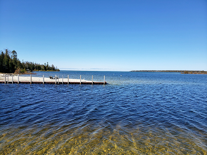 Drummond Island Dock: Simple wooden docks extend into crystal-clear blue waters, inviting you to dip your toes or cast a line into Lake Huron's refreshing embrace.