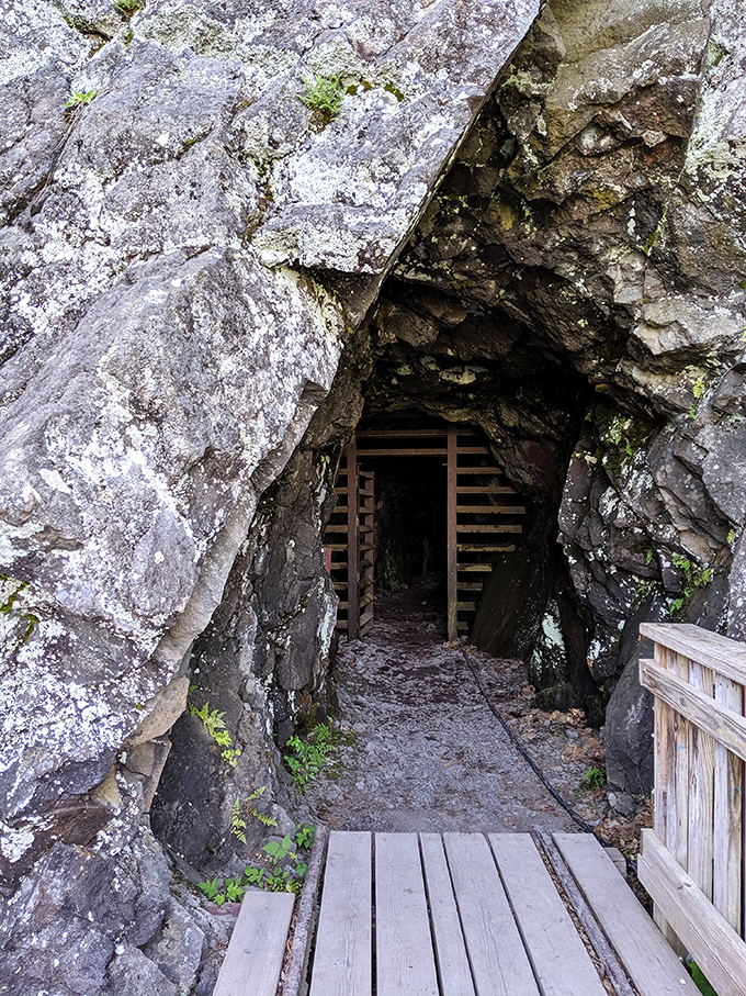 The unassuming entrance belies what awaits below, a wooden-framed portal to Michigan's rich mining heritage and underground wonders.
