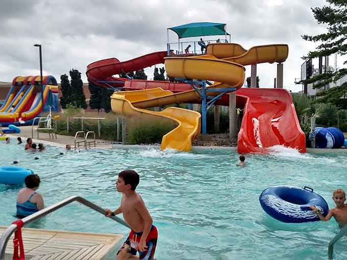 The outdoor pool complex features zero-depth entry and multiple slides, creating the perfect playground for water lovers of all ages.