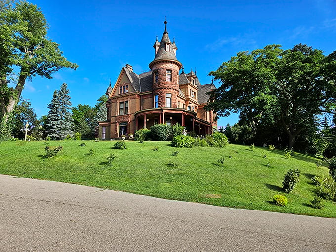 Henderson Castle's striking Queen Anne architecture makes an impressive statement against Michigan's blue skies, its turret reaching skyward like a fairy tale come true.