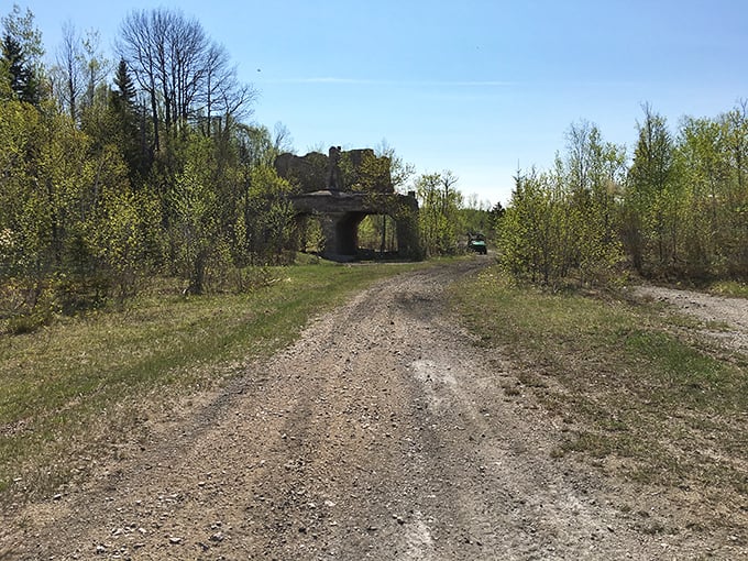 The road less traveled leads to forgotten industrial glory, where limestone walls stand sentinel against time's passage through Michigan's wilderness.