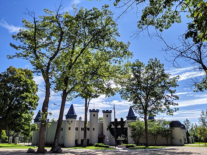 The castle's cream-colored walls contrast beautifully with distinctive blue-capped spires, creating an unforgettable silhouette against Michigan's skies.