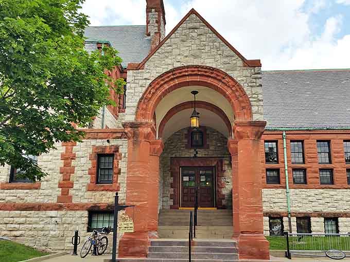 Romanesque arches and contrasting stonework create a dramatic entrance, inviting visitors to step back in time while stepping into knowledge.