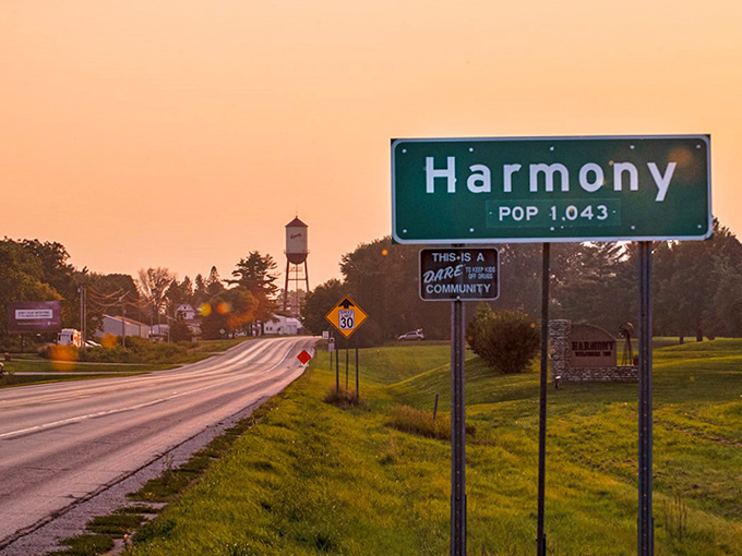 The "Population 1,043" sign welcomes visitors at sunset, promising small-town magic where even the golden hour seems to linger longer.