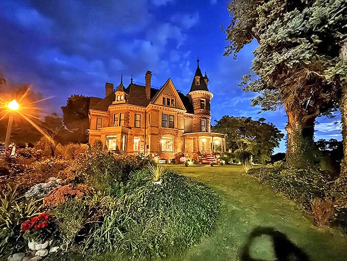 Henderson Castle at Night: As twilight embraces the castle, windows glow with warm invitation&mdash;or is it spectral activity? Either way, the night view is hauntingly beautiful.
