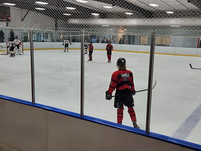 Hockey players take to the ice during practice, showcasing the arena's versatility beyond just recreational skating.
