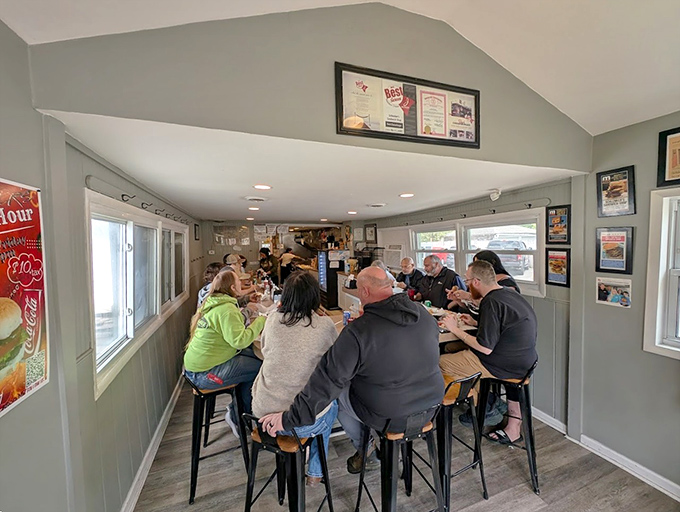 Inside, the cozy dining area buzzes with conversation as locals and food pilgrims alike gather to experience burger perfection.