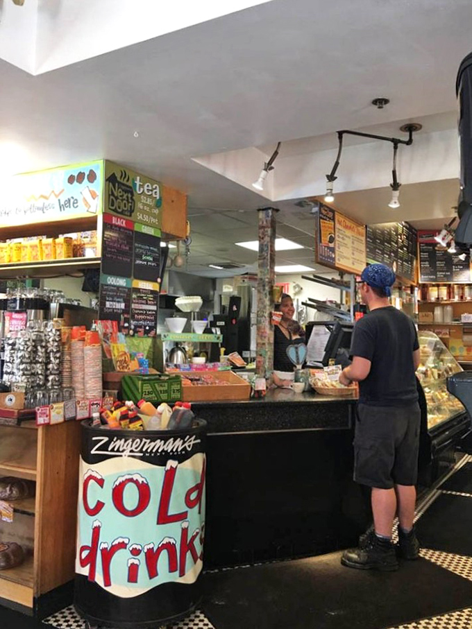 Inside, the bustling counter buzzes with energy as baristas craft perfect drinks amid handwritten menus and the intoxicating aroma of freshly ground beans.