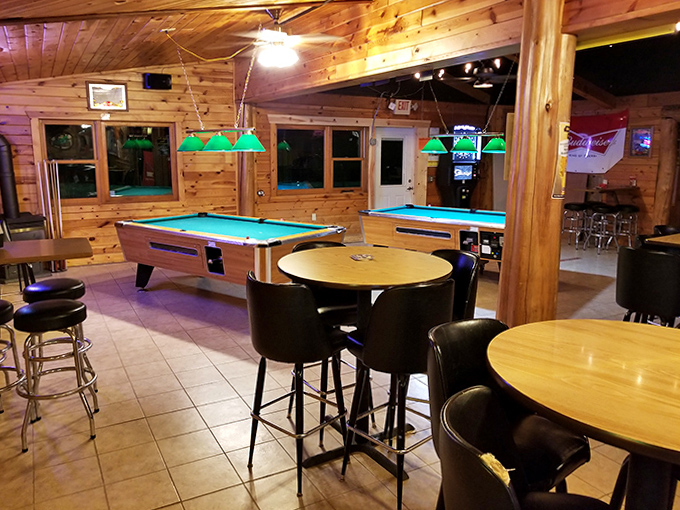 Warm wood paneling and green-shaded pool tables create the perfect backdrop for evening competitions and friendly challenges among locals and visitors alike.
