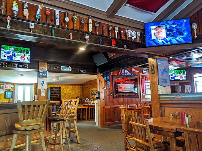Step inside to discover a warm interior where beer tap handles line the ceiling and college pennants create a colorful canopy above.