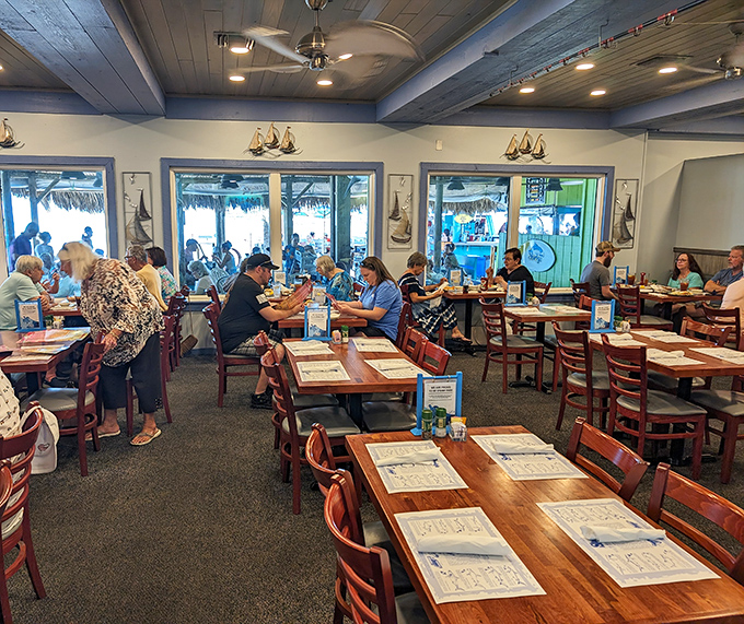 Where seafood stories are born: The indoor dining area offers Gulf views through panoramic windows and a taste of coastal comfort.