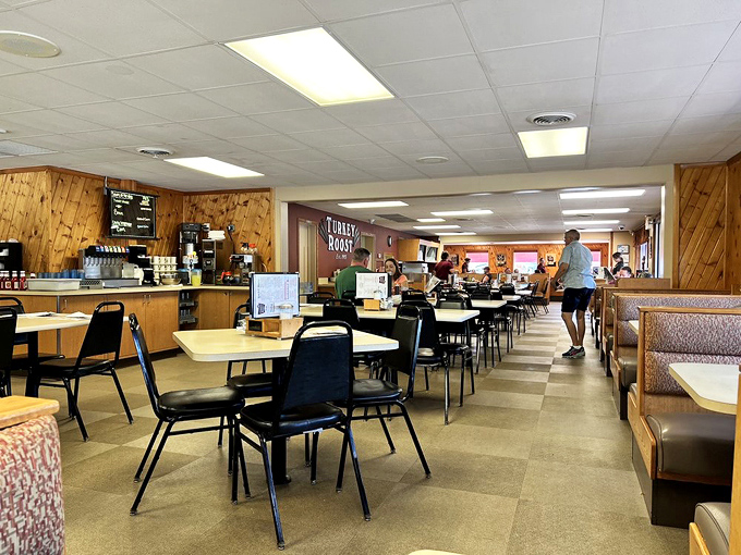 Wood-paneled walls and no-nonsense furnishings create a time capsule of mid-century dining where conversations flow as freely as the gravy.