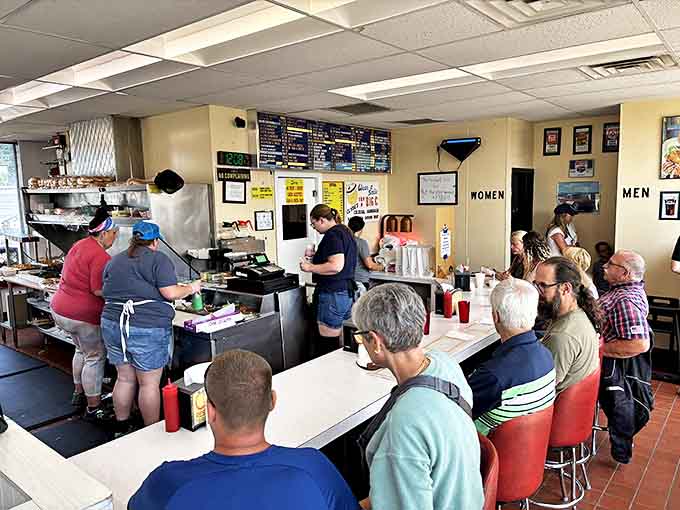 Interior: Where burger dreams come true &ndash; locals line the counter at Clyde's, participating in a ritual that's equal parts ordering and social gathering.