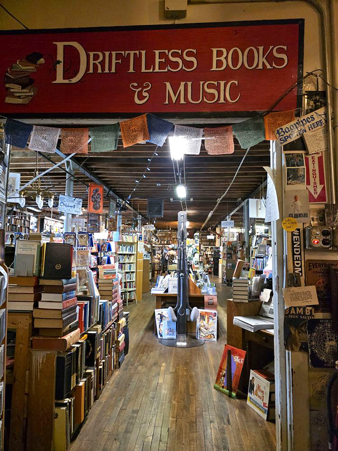 Driftless Books & Music welcomes bibliophiles with its vibrant red sign, colorful prayer flags, and the promise of literary adventures.