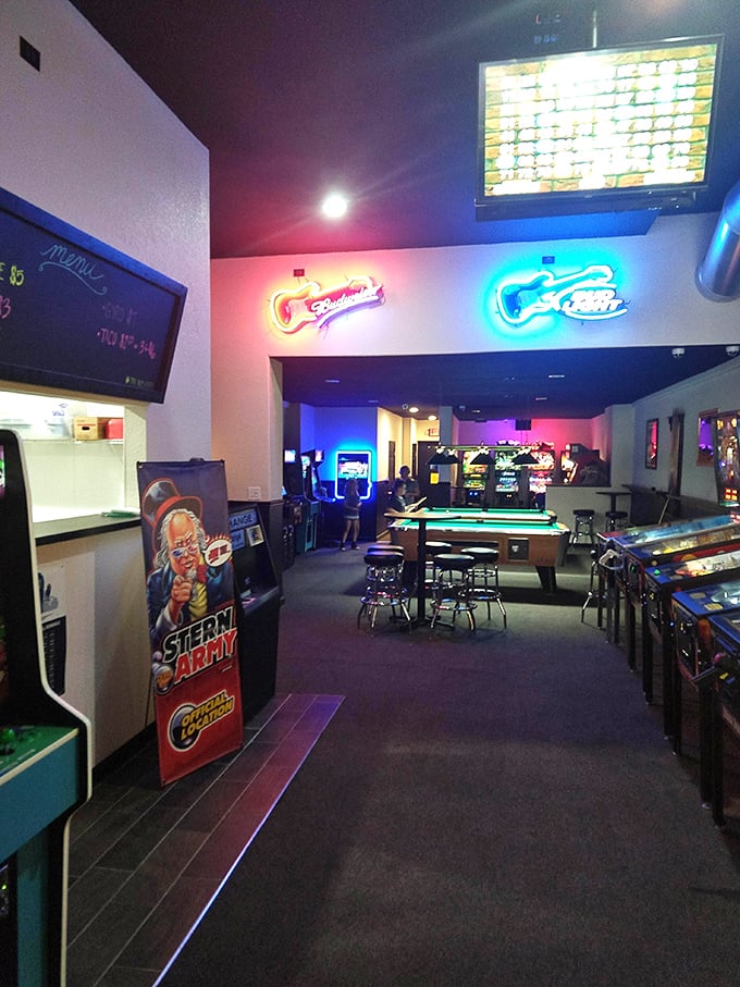 Inside Tilted, the glow of arcade screens bathes everything in nostalgic light while pool tables and gaming cabinets create a playground for grown-ups.