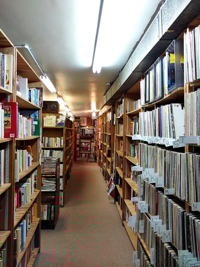 Narrow aisles create a book lover's labyrinth where time slows down and the outside world fades away among wooden shelves heavy with stories.