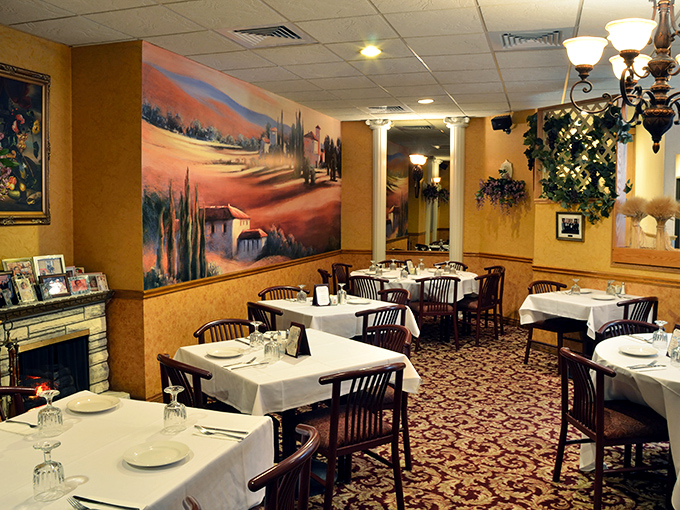 Golden walls adorned with Tuscan landscapes transport diners straight to Italy, while white tablecloths signal the kitchen's serious approach to authentic cuisine.