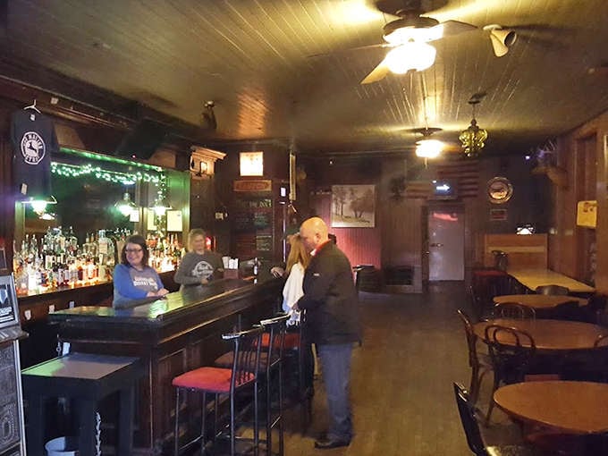 Interior: Wood-paneled walls and vintage ceiling fans create an atmosphere where time slows down and conversations flow as freely as the drinks.