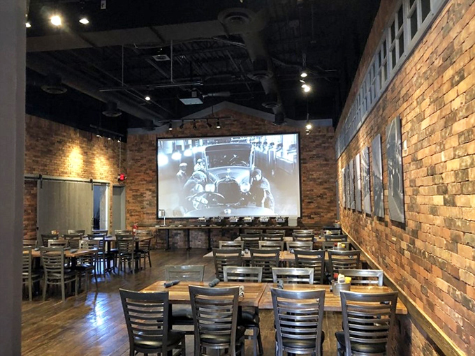 Step inside and discover a dining room where industrial chic meets automotive history, brick walls, garage-door tables, and napkins cleverly secured with actual hose clamps.