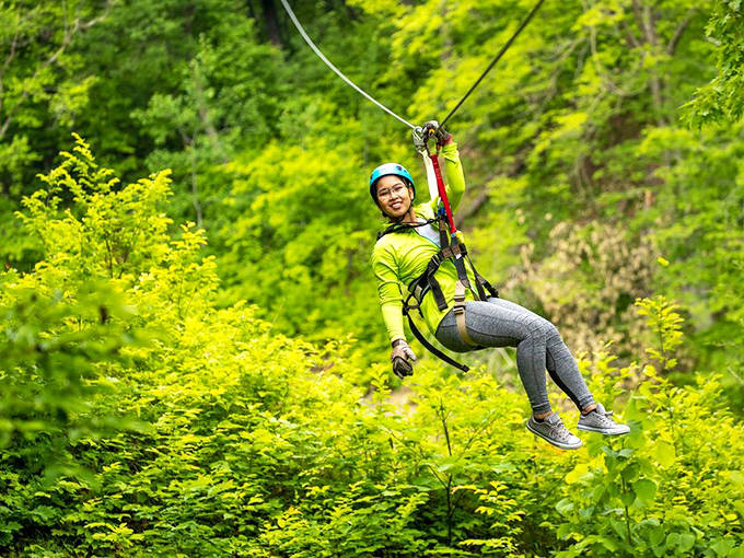 Gravity becomes your best friend as you soar through vibrant spring foliage, your smile competing with the brightness of the surrounding greenery.