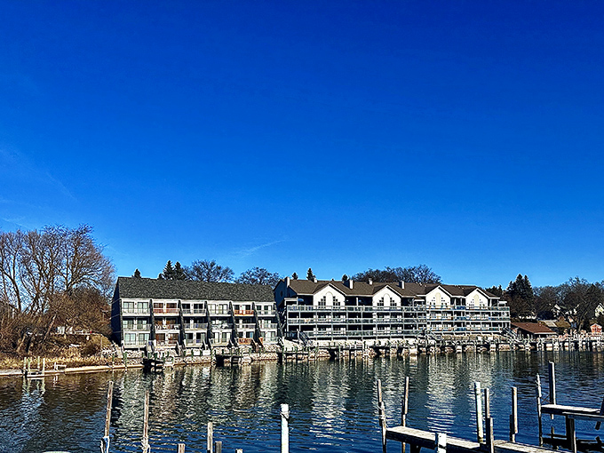 Manistee's Riverwalk offers front-row seats to the dance between river and architecture, where boats glide past historic buildings with storybook charm.