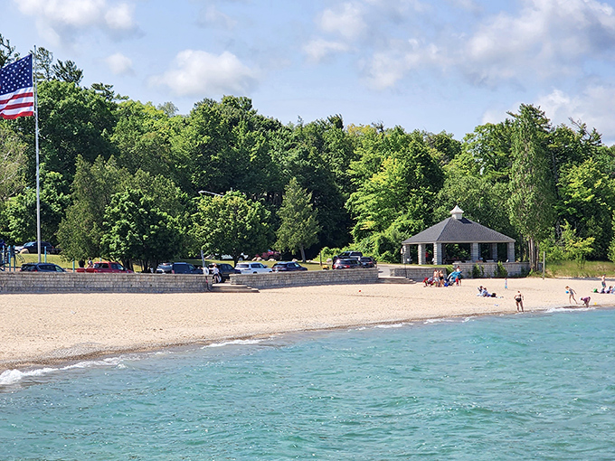 Beach day perfection: soft sand meets crystal waters under an endless blue sky at Michigan Beach Park's inviting shoreline.