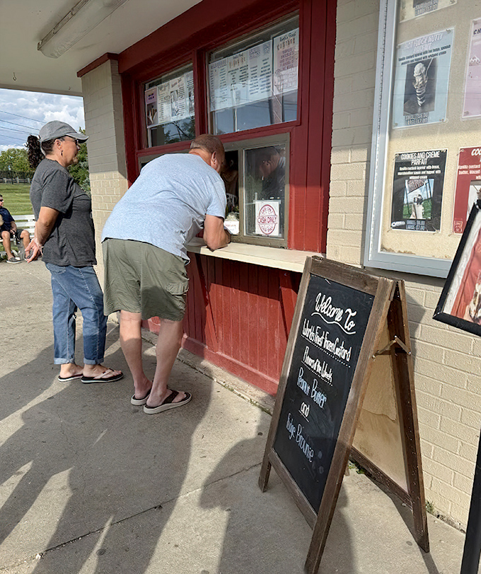 At this nostalgic window, dreams come true one scoop at a time, as customers eagerly await their frozen treasures.