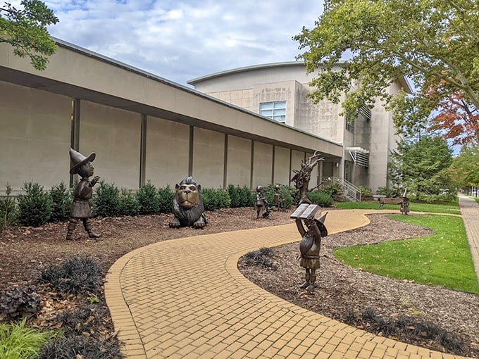 Bronze characters from Oz stand sentinel along the winding path, inviting visitors to join them on an adventure through a beloved American classic.