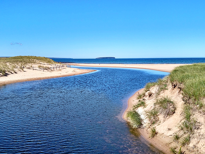Nature's perfect meeting point: Au Train River embraces Lake Superior in a swirl of blues that would make artists weep.