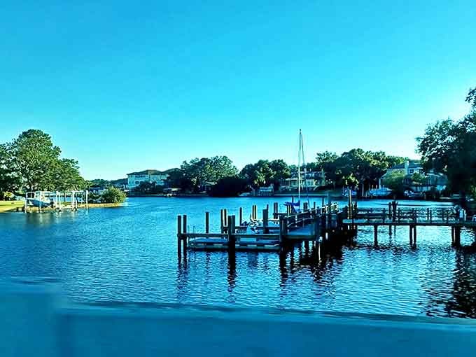Wooden docks stretch into calm waters where fishing boats and pleasure craft bob gently, promising adventures beyond the shoreline.